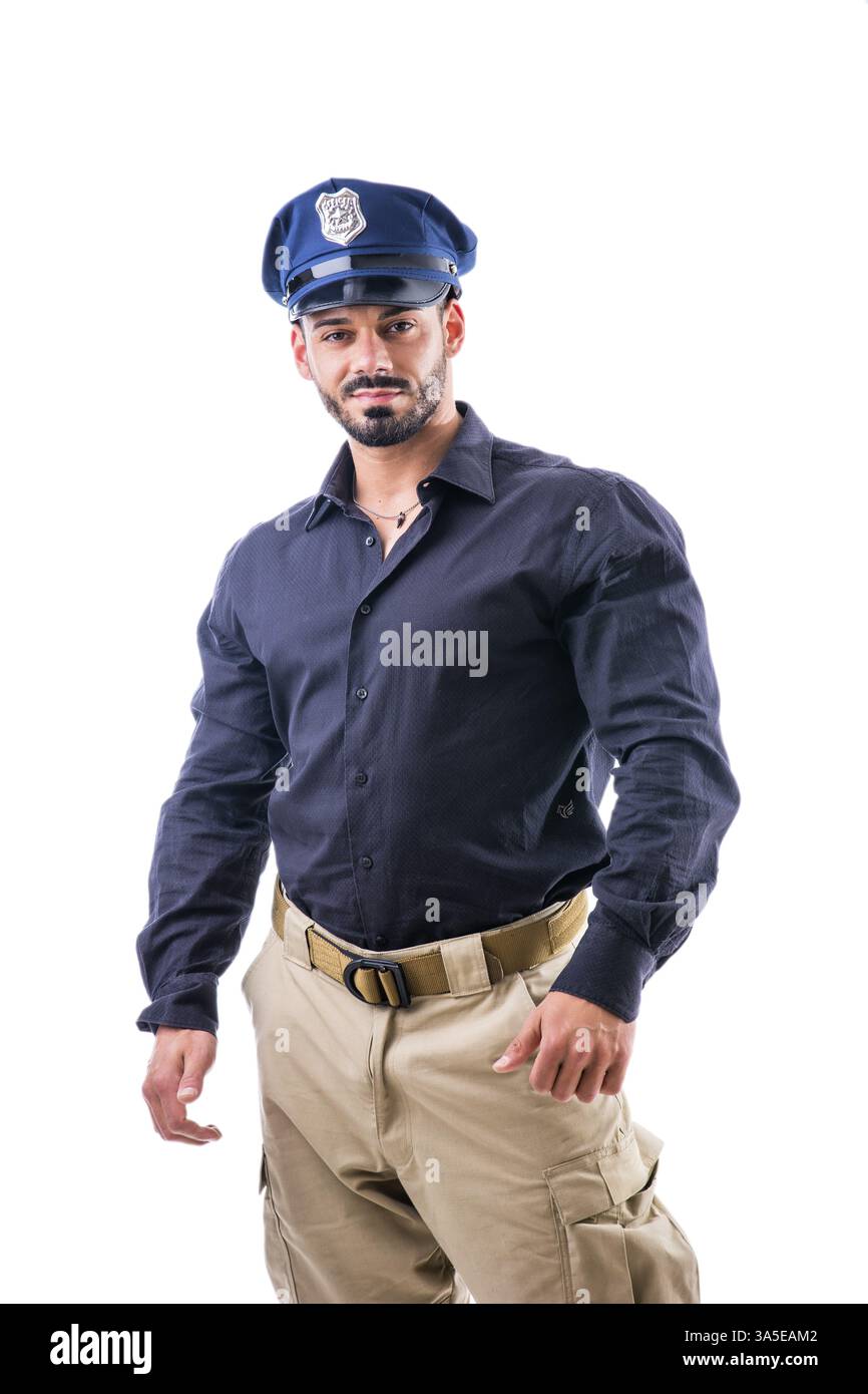 Handsome muscular male posing confidently in police cap and uniform on ...