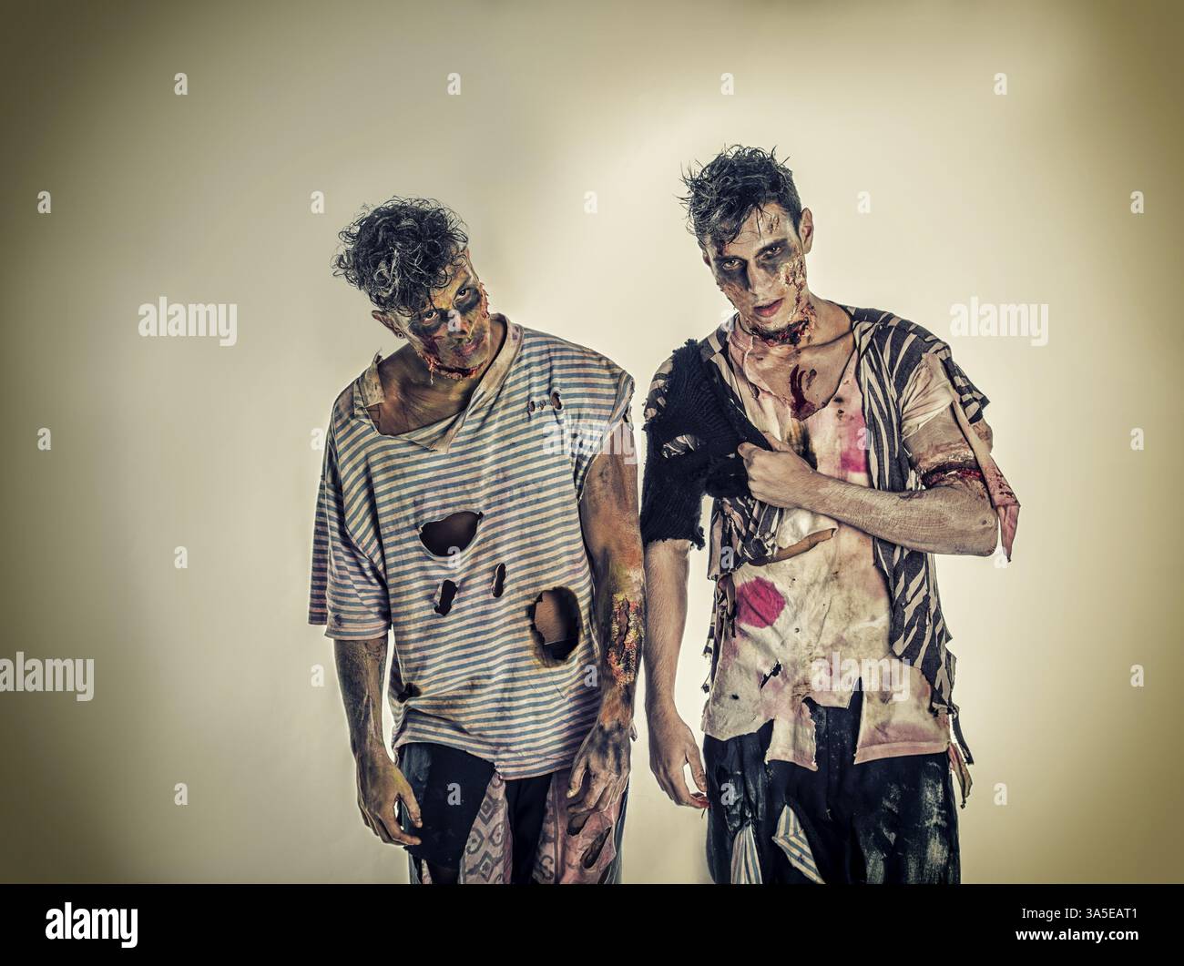 Two male zombies standing on black smoky background, head and shoulder ...