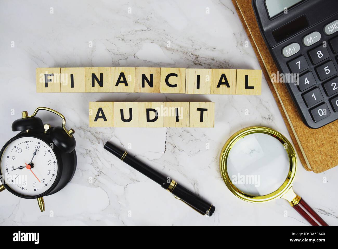 Financial Audit with wooden blocks alphabet letters and Magnifying ...