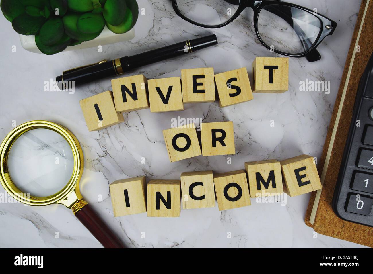 Invest or Income with wooden blocks alphabet letters and Magnifying ...