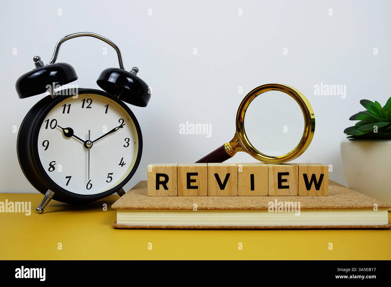 Magnifying glass and alarm clock with wooden blocks alphabet letters ...