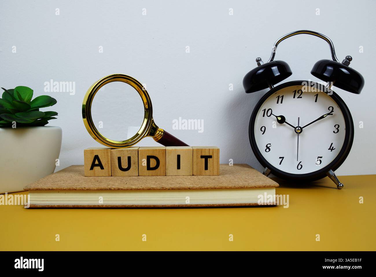 Magnifying glass and alarm clock with wooden blocks alphabet letters ...