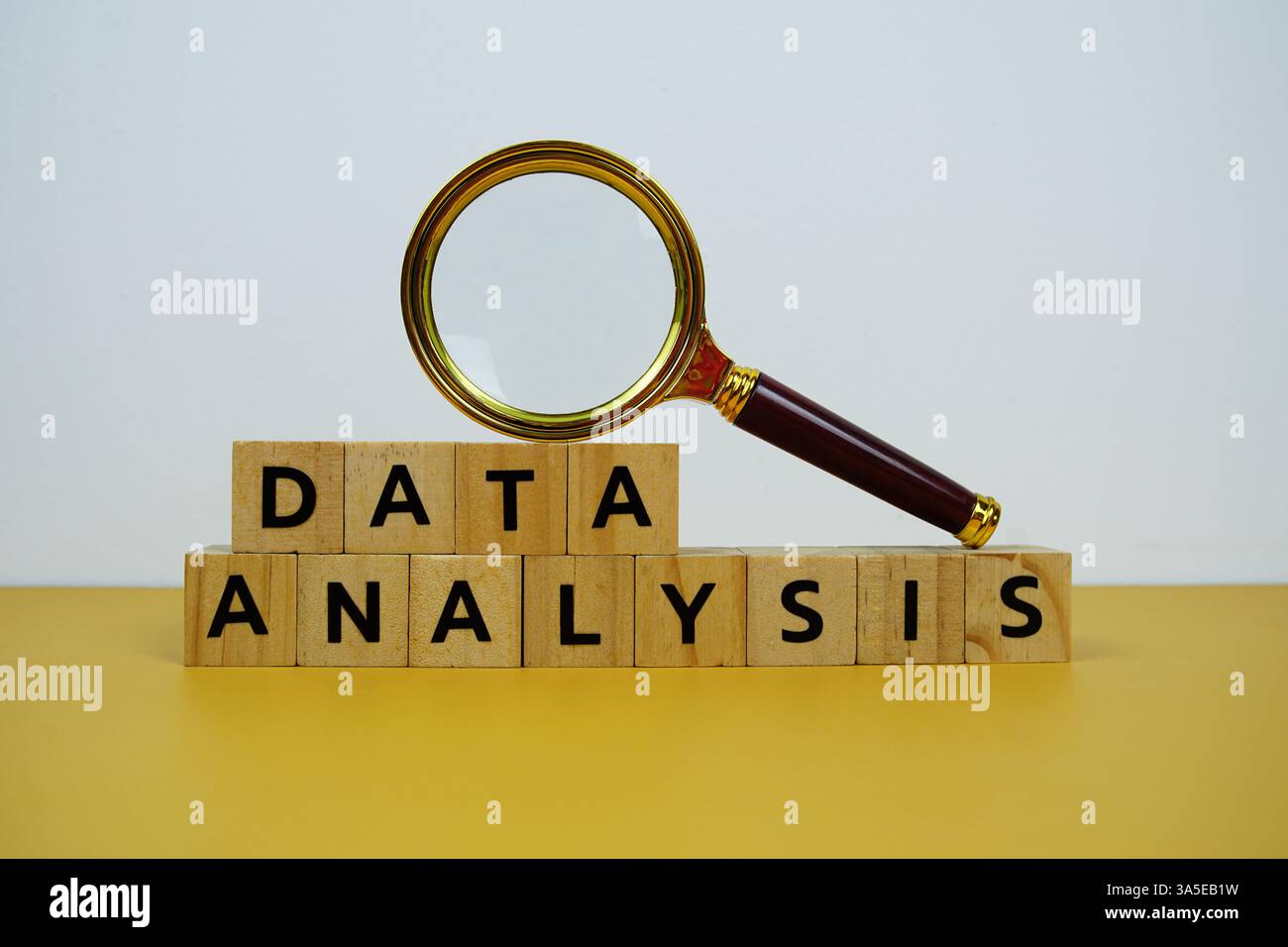 Magnifying glass with wooden blocks alphabet letters DATA ANALYSIS text ...