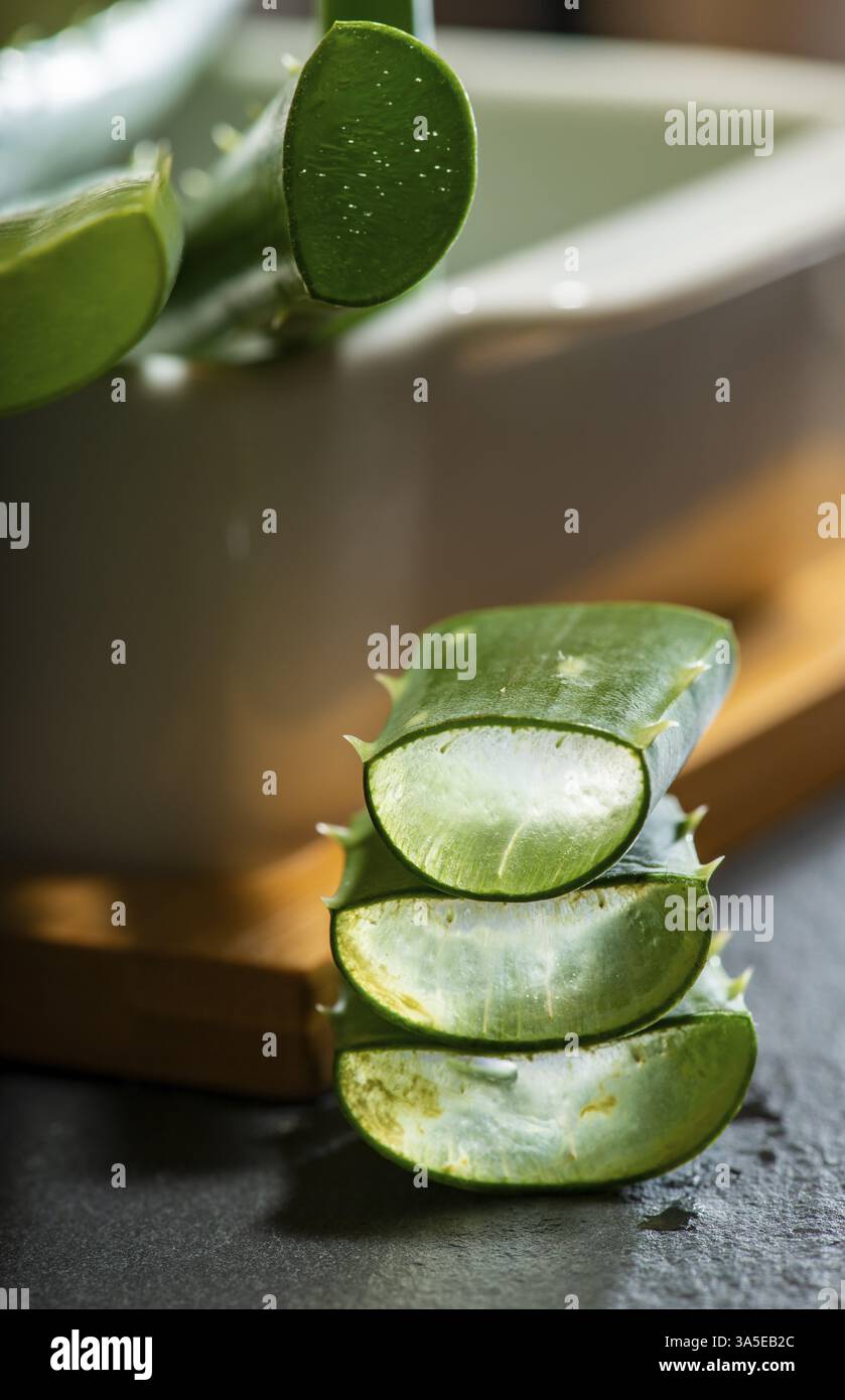 Aloe vera slices on dark background. Health and beauty concept. Closeup ...