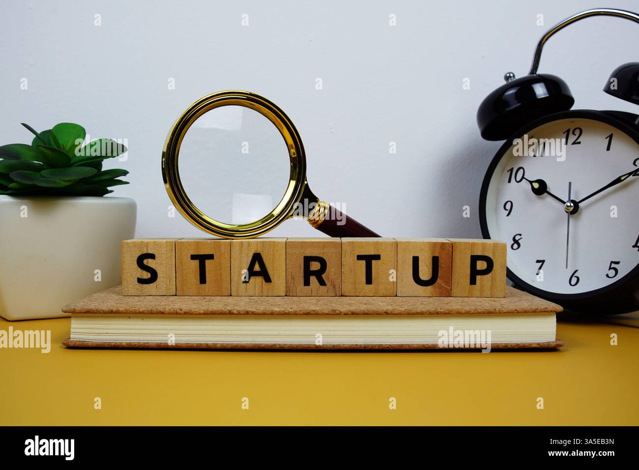 Magnifying glass and alarm clock with wooden blocks alphabet letters ...