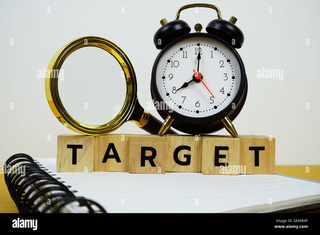 Magnifying glass and alarm clock with wooden blocks alphabet letters ...