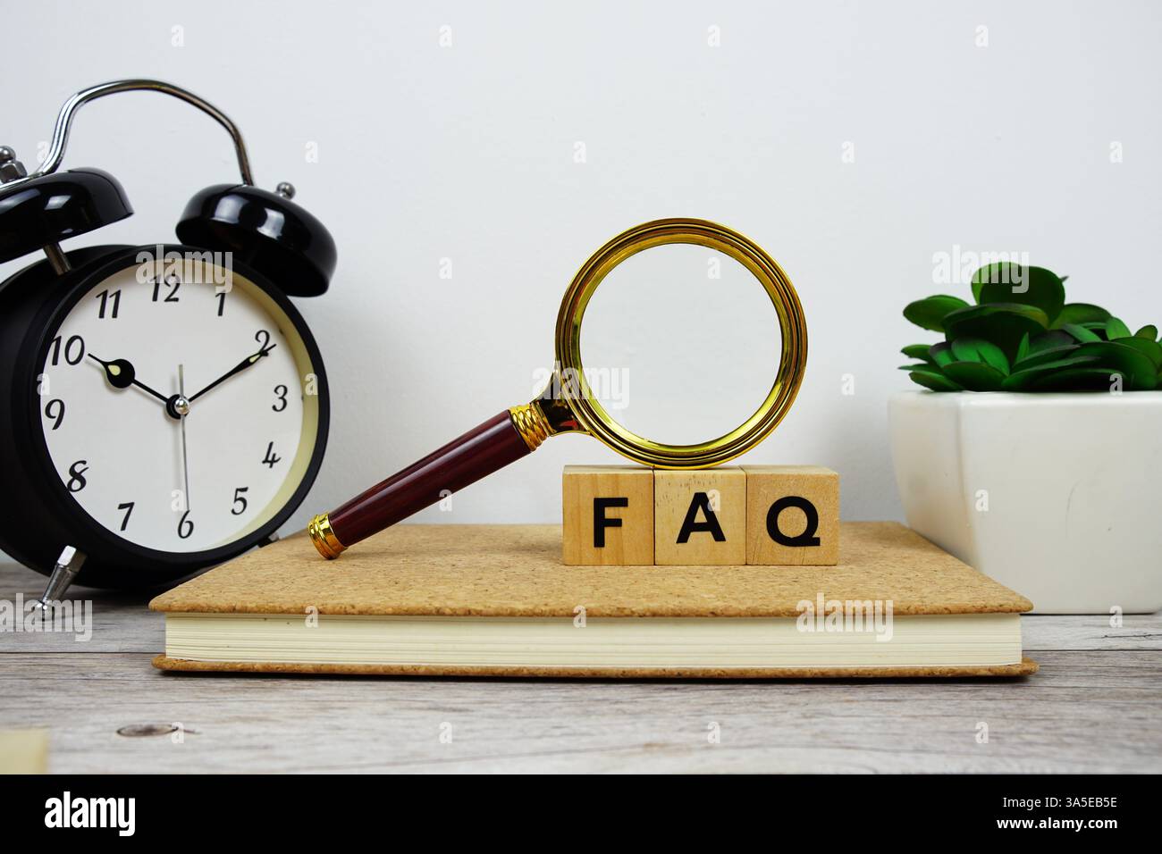 Magnifying glass and alarm clock with wooden blocks alphabet letters ...