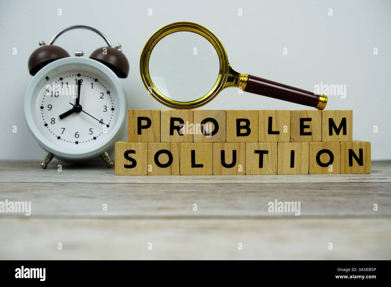 Magnifying glass and alarm clock with wooden blocks alphabet letters ...