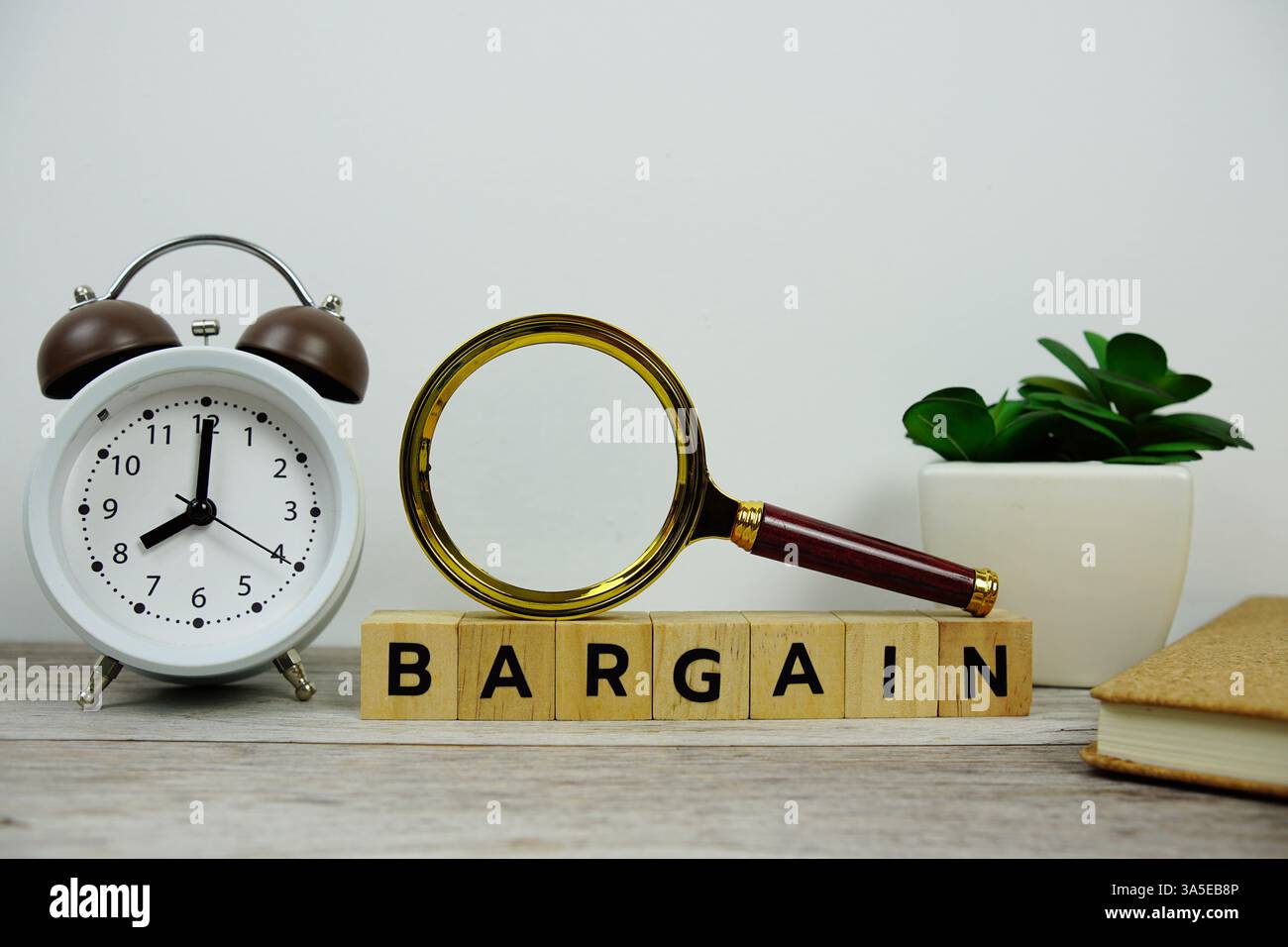 Magnifying glass and alarm clock with wooden blocks alphabet letters ...