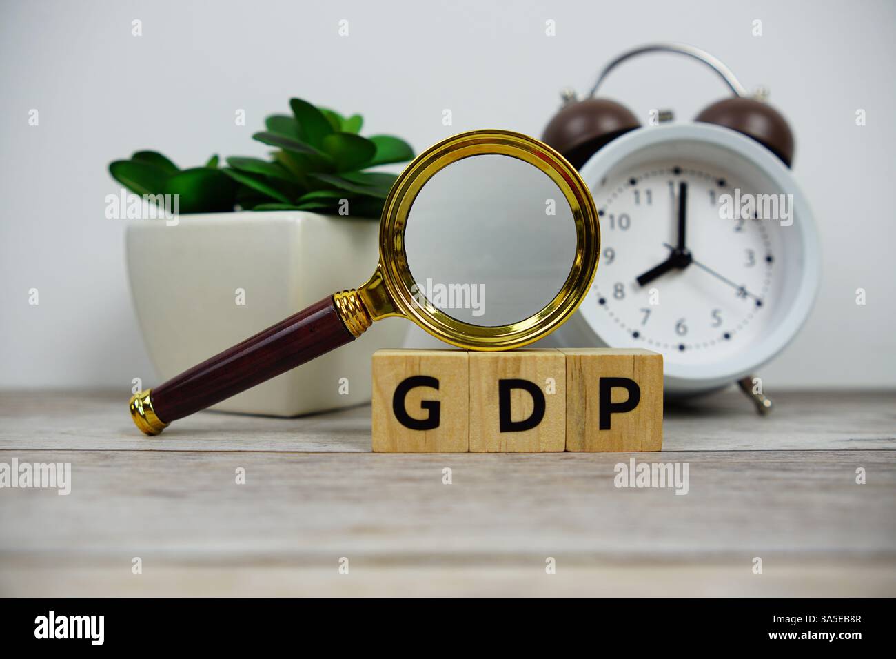 Magnifying glass and alarm clock with wooden blocks alphabet letters ...