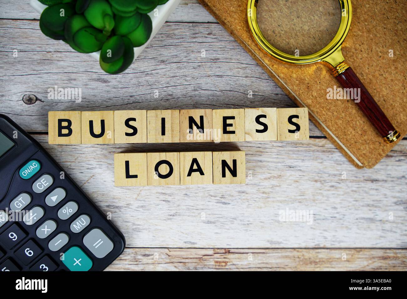 Magnifying glass and calculator with wooden blocks alphabet letters ...