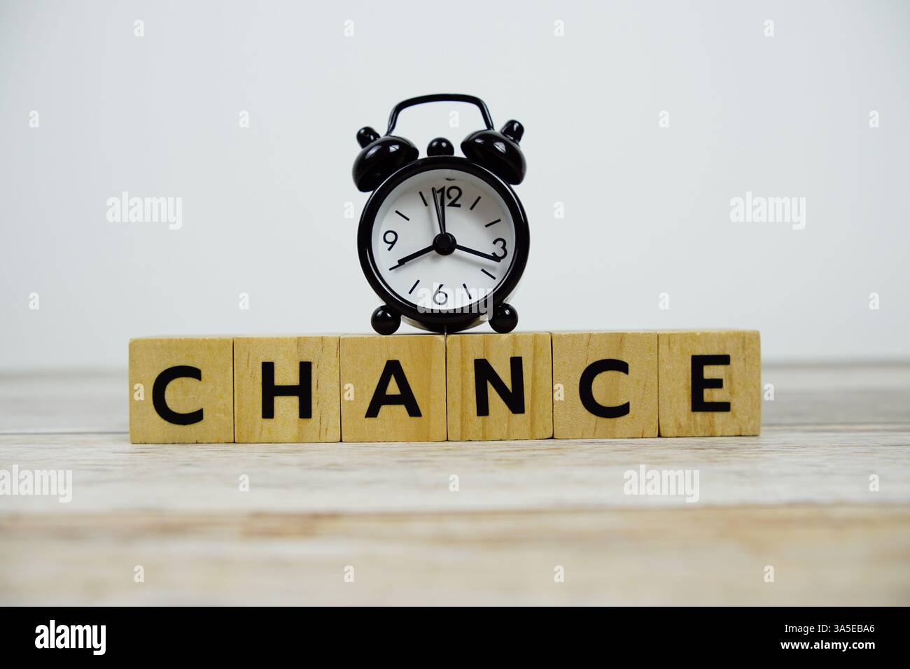 Time to Chance with wooden blocks alphabet letters and alarm clock on ...