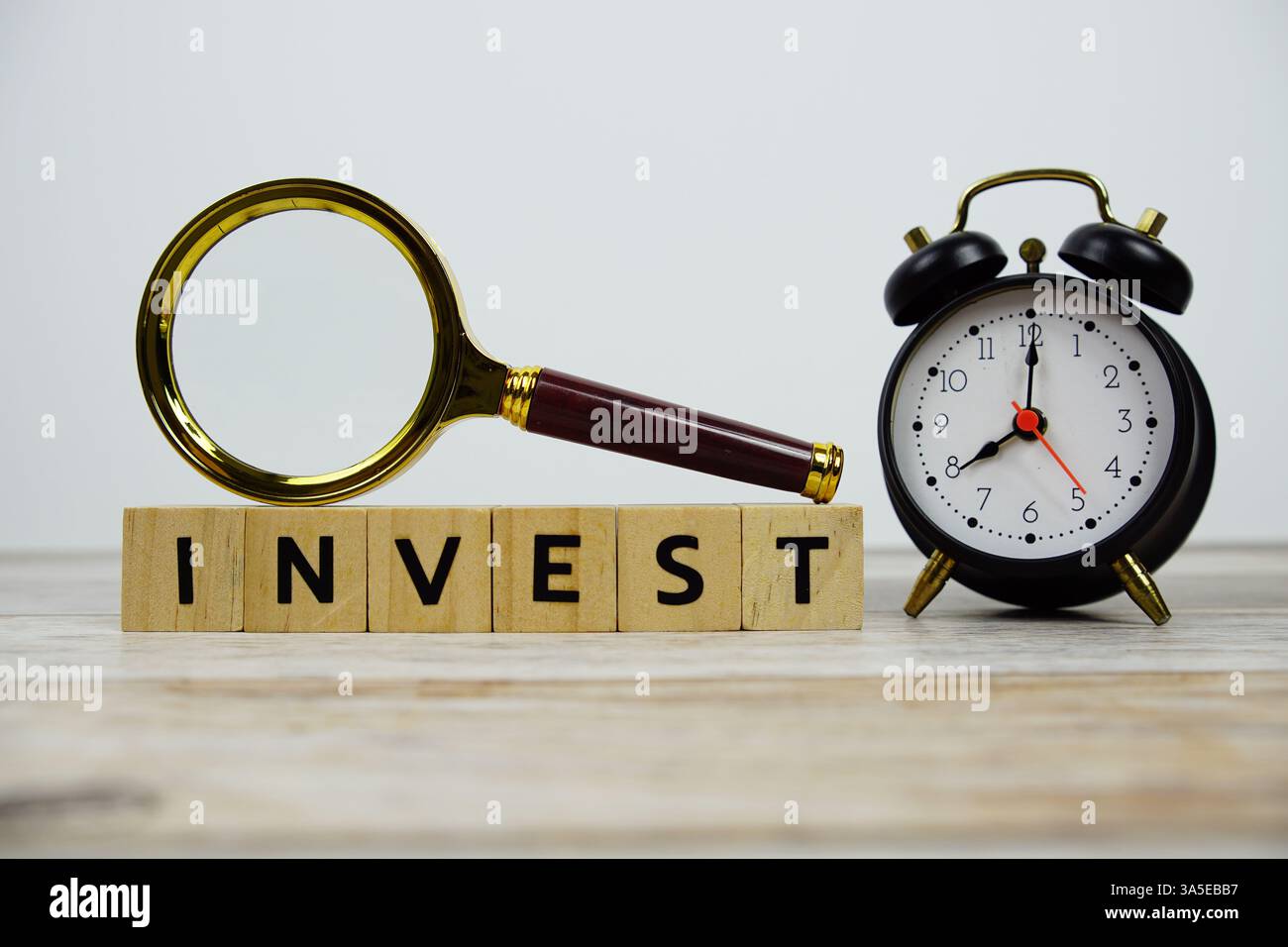 Time to Invest with wooden blocks alphabet letters and Magnifying glass ...
