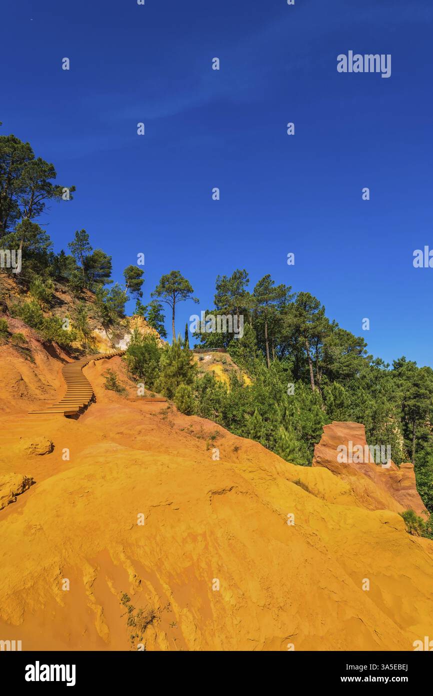 Steps for tourists on a steep slope. Unique red and orange hills in the ...