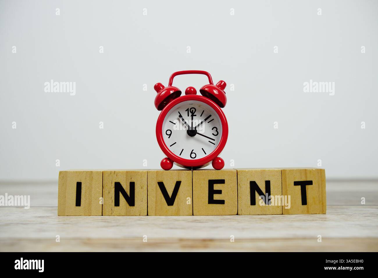 Time to Invent with wooden blocks alphabet letters and alarm clock on ...