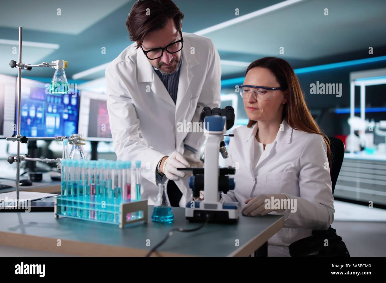 Scientist couple conducting experiments in hospital lab with state-of ...