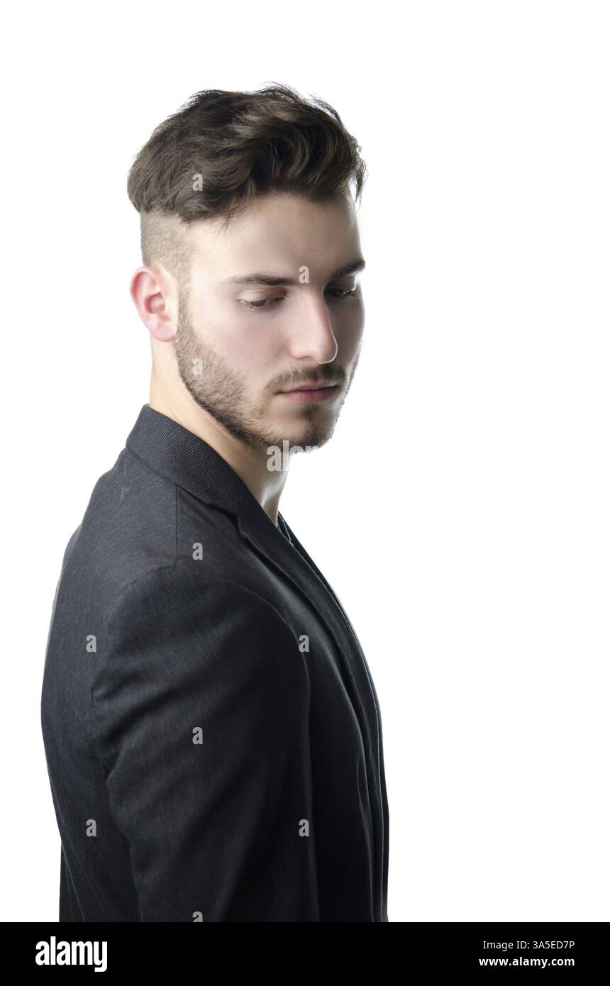 Attractive young business man looking down, serious expression ...