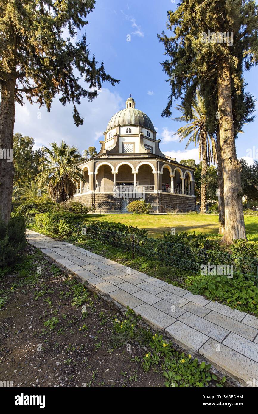 Magnificent monastery surrounded by columns and slender tall palms. The ...