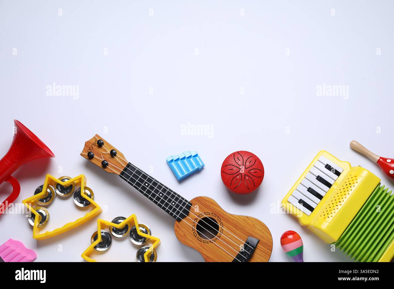 Flat lay composition with different toy musical instruments on white ...