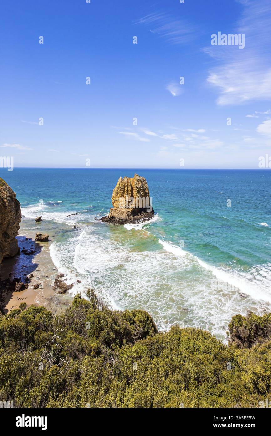 Coastal rocks in the foam of the ocean surf. Pacific coast and sandy ...
