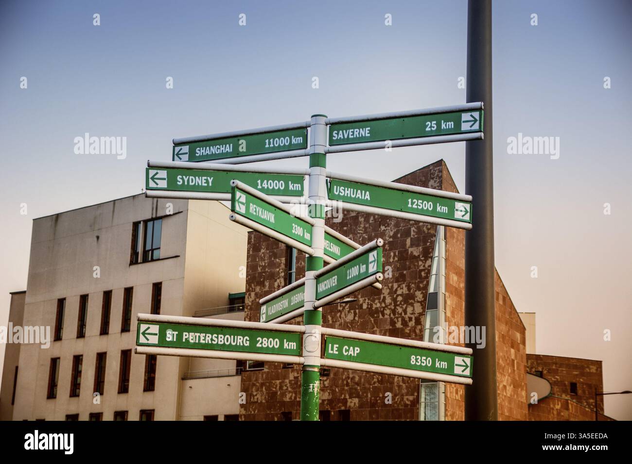 Different geographical locations on crossroad signs against of ...