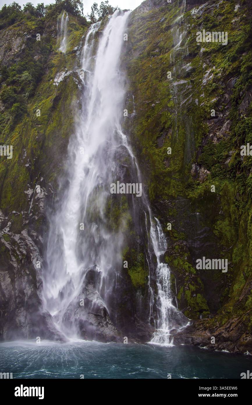 Magnificent powerful waterfall crashes down from the cliff. Magical ...
