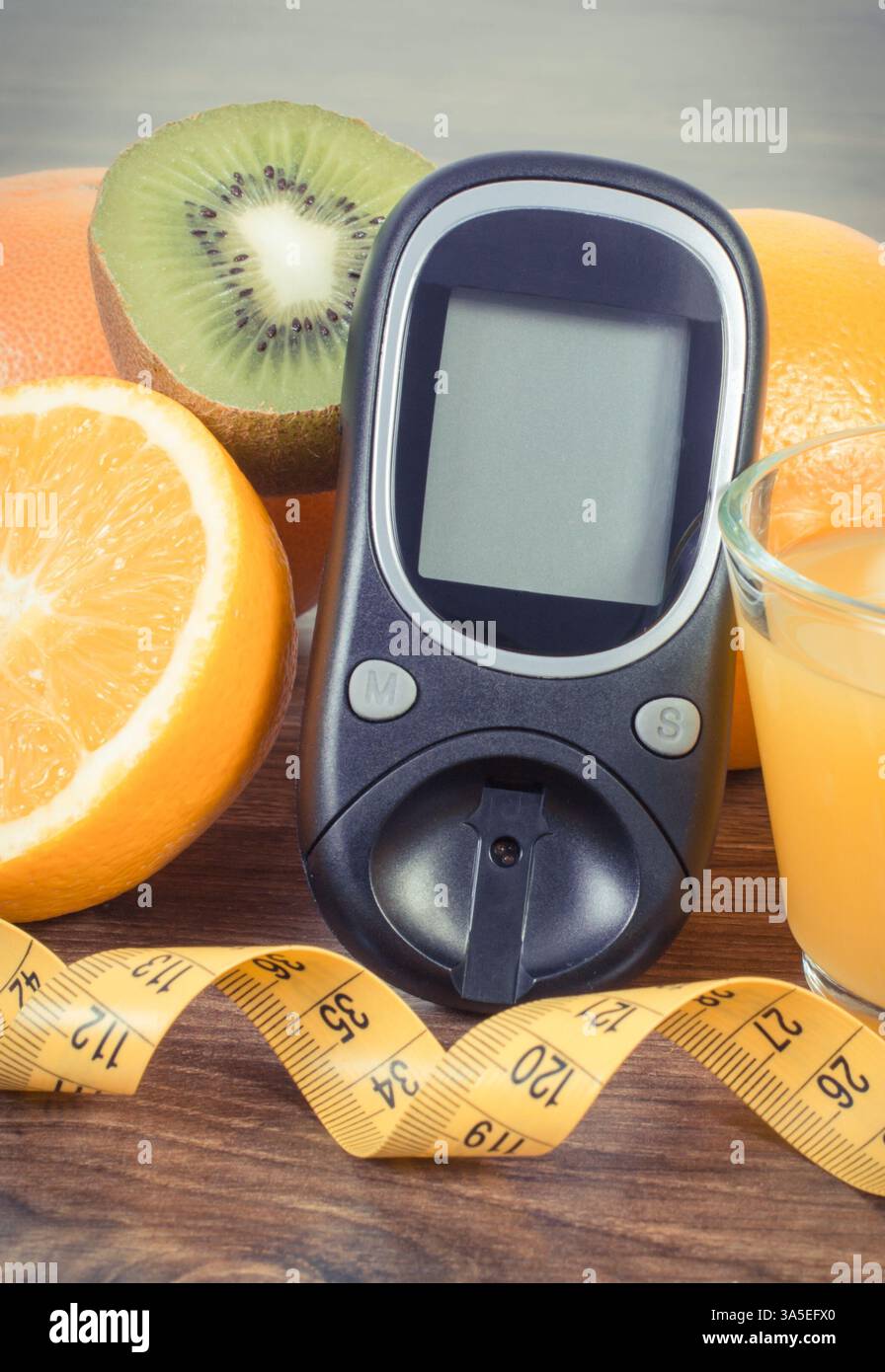 Glucose meter for measuring and checking sugar level, fresh ripe fruits ...