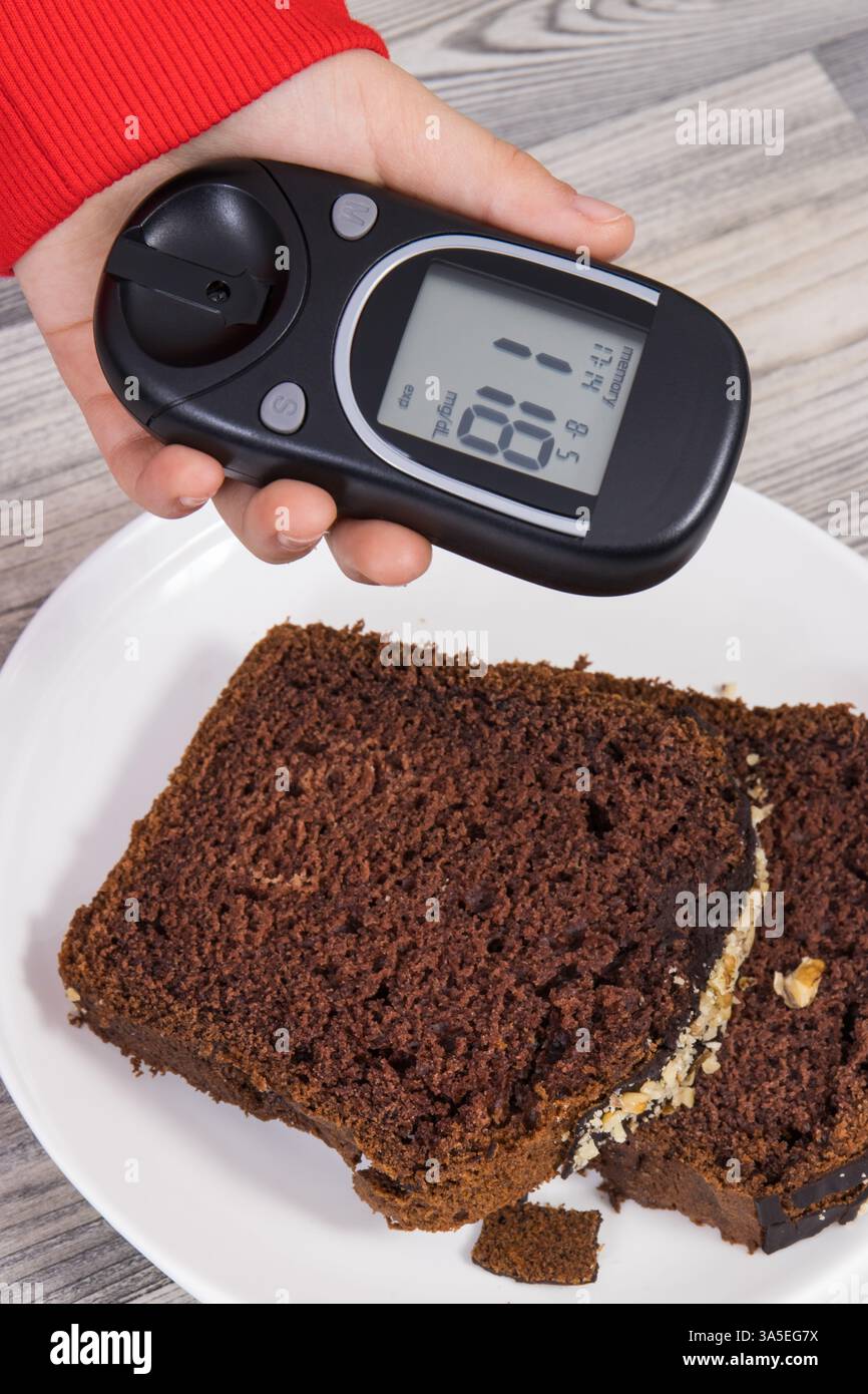 Hand of child holding glucometer with result of measurement sugar level ...