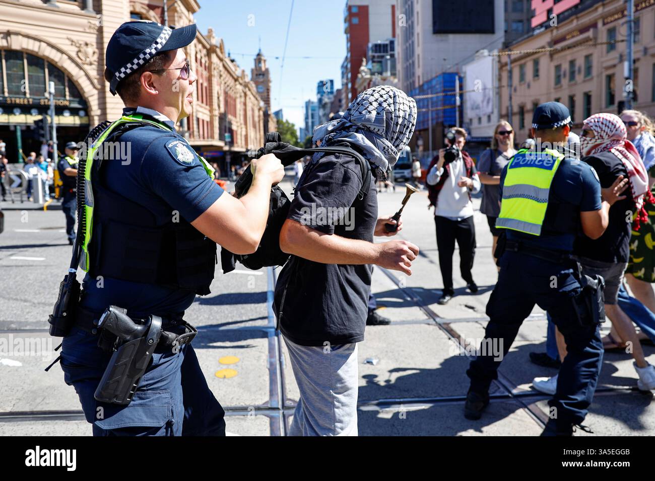 Victoria Police attempts to stop protesters during the rally. The rally ...