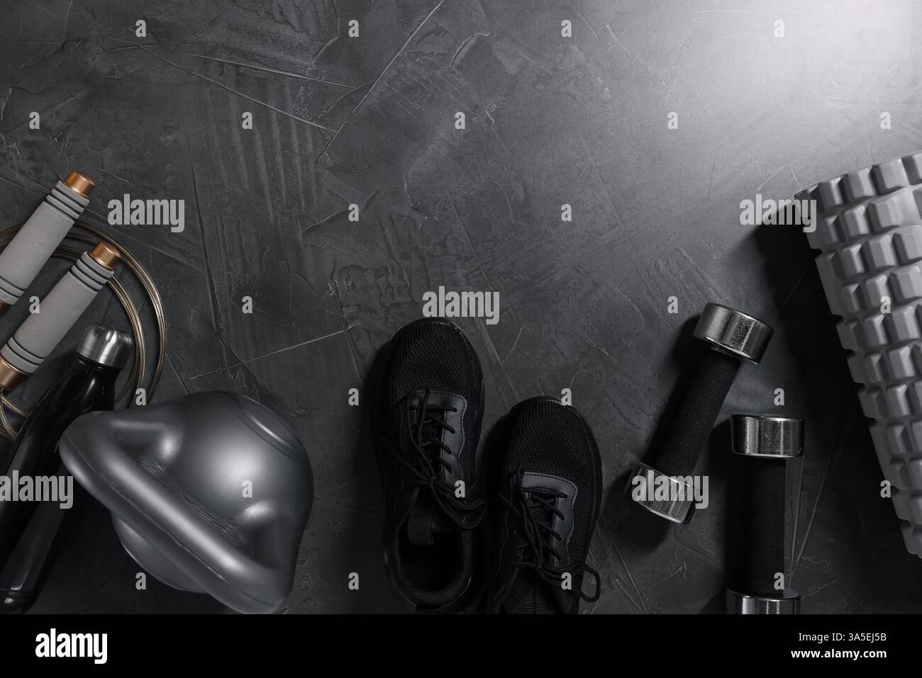 Different gym stuff on grey textured background, flat lay. Space for ...