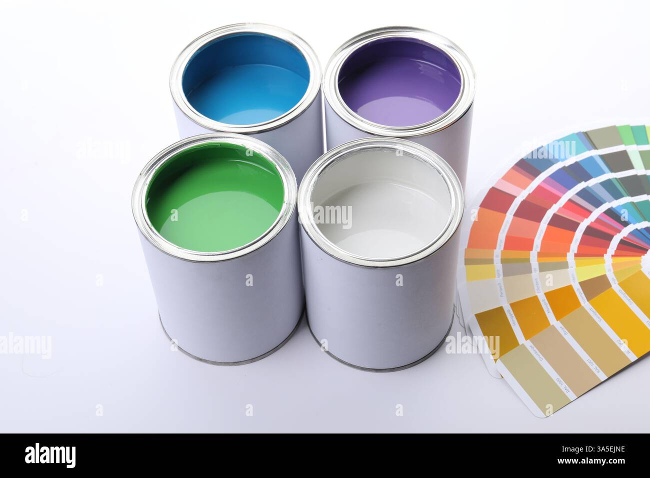 Cans of bright paints and color palettes on light background Stock ...