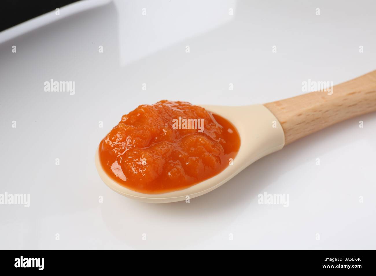 Baby food. Tasty puree in spoon isolated on white Stock Photo - Alamy