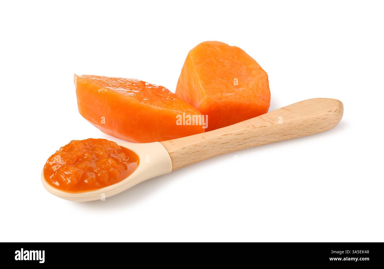 Baby food. Tasty puree in spoon and persimmon isolated on white Stock ...