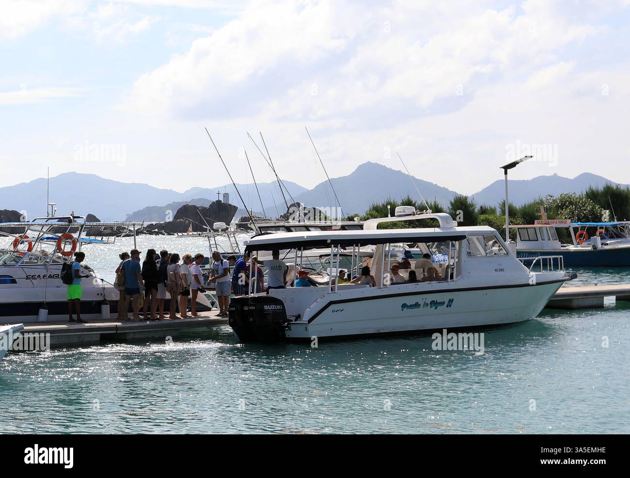 Victoria, Seychelles. 15th Mar, 2025. Tourists queue to board a yacht ...