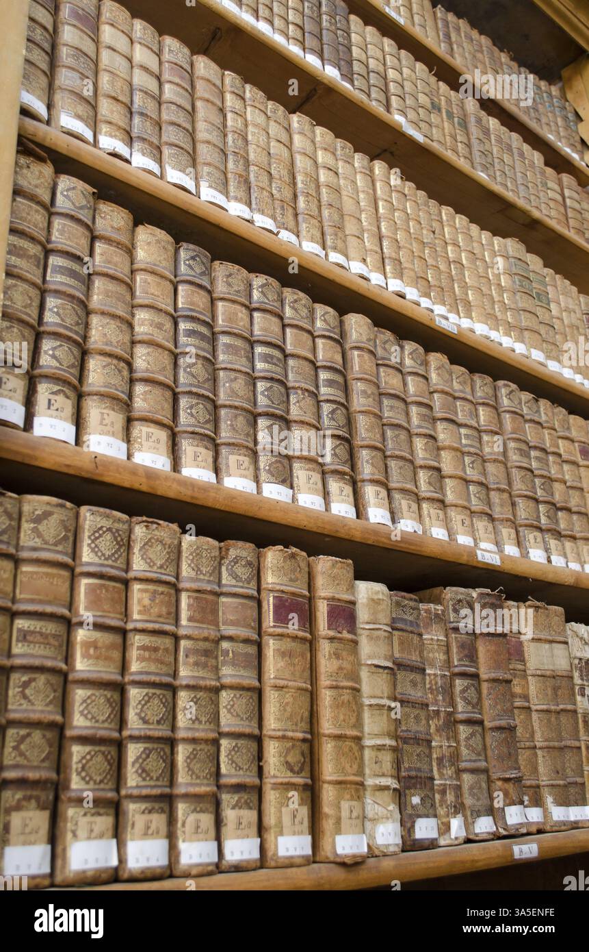 Shelves in antique library full of very old books hi-res stock ...