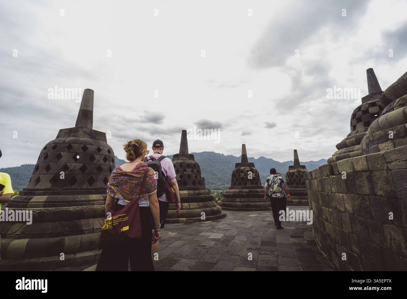 Visitors explore the temple's stone formations with impressive views of ...