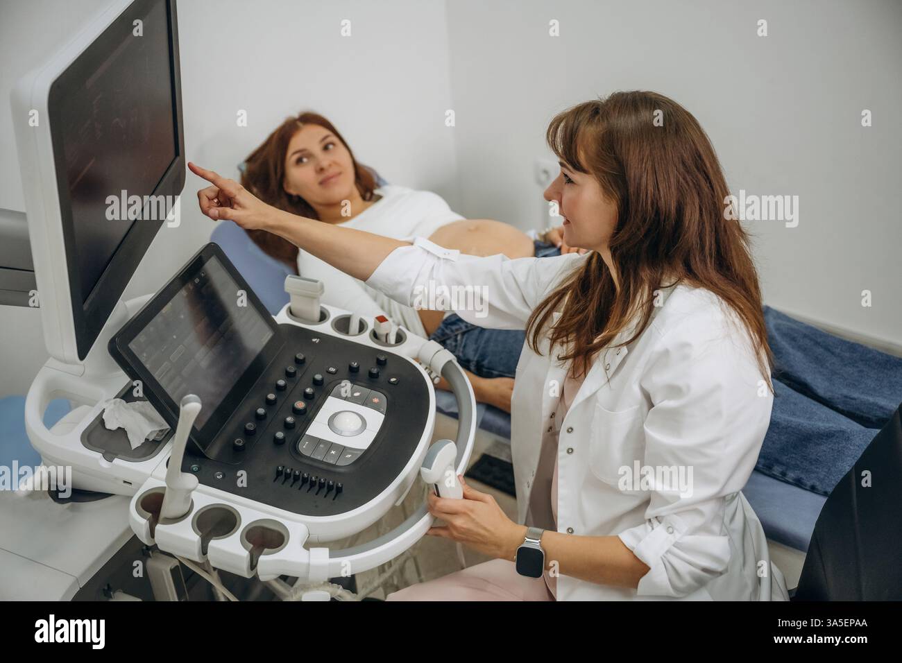 Scanning in progress. Pregnant woman undergoing ultrasound test Stock ...