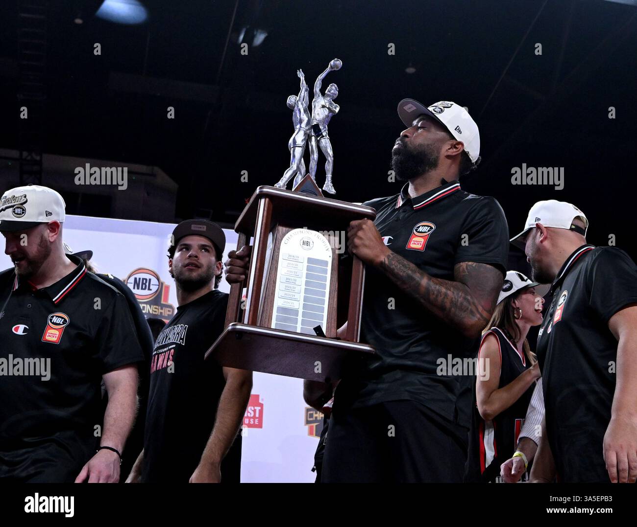 Hawks coach Justin Tatum celebrate with the NBL trophy following their ...