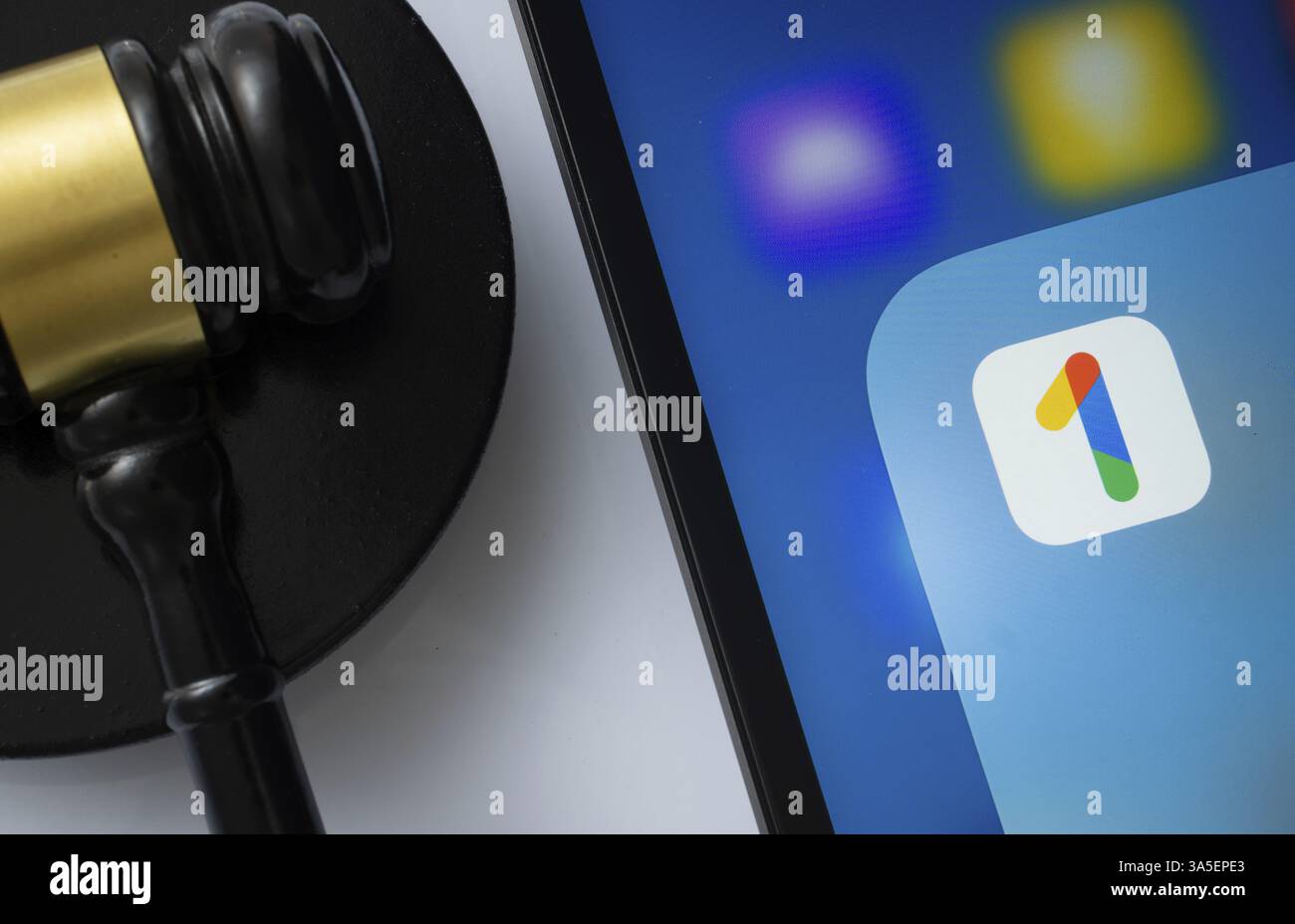 A close up of an iPad screen displaying the google one app alongside a ...