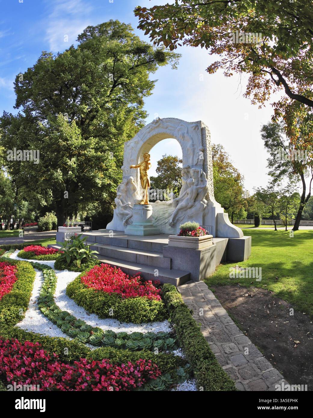Elegant marble arch frames the bronze statue of Johann Strauss ...