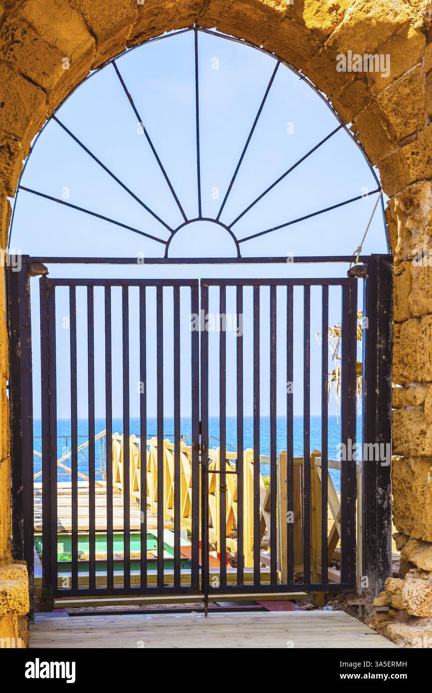 Lattice gates closed arched doorway of the port. National park Caesarea ...