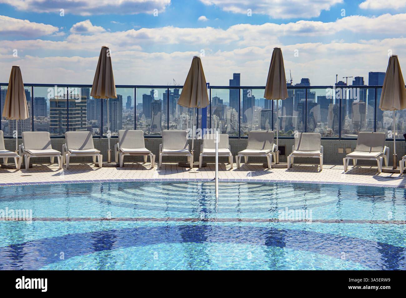 Rooftop pool of a high-rise hotel. The round bowl of the pool is filled ...