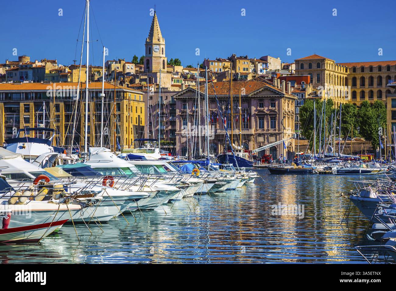 The blue water reflects the ancient buildings on the waterfront. Rows ...