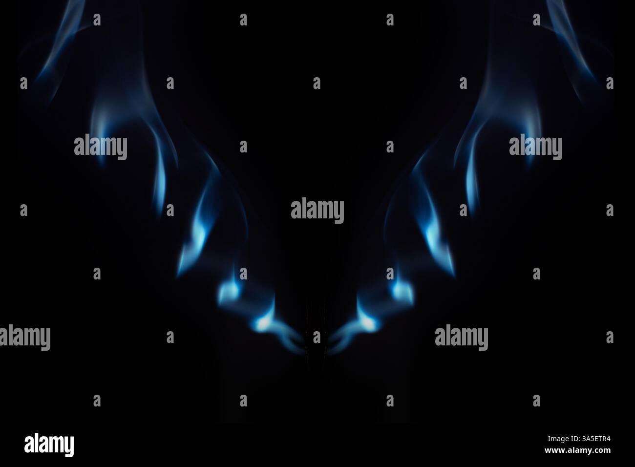 Abstract blue flames forming a symmetrical pattern on a dark background ...