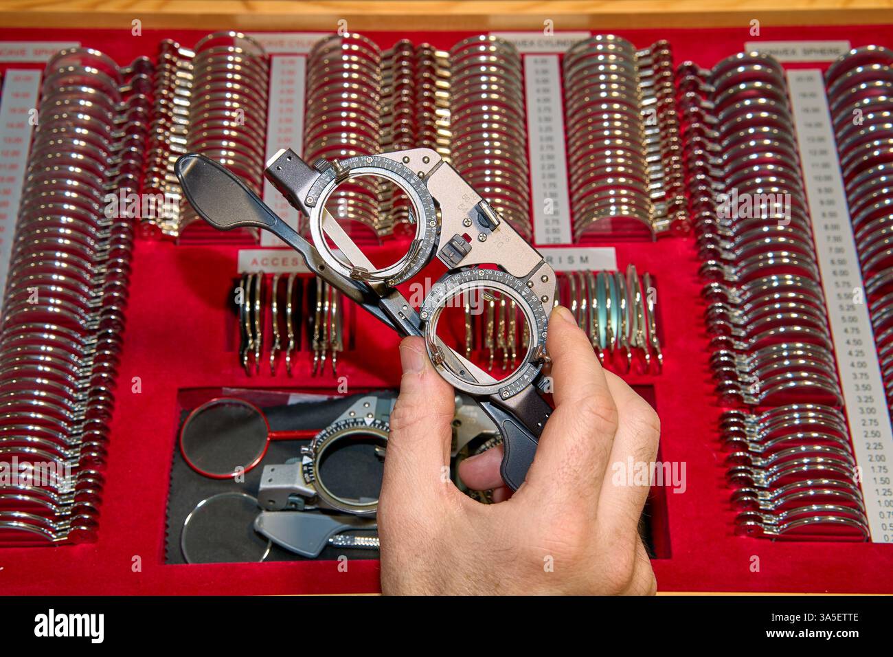 Crop unrecognizable hand of optician holding test glasses for measuring ...