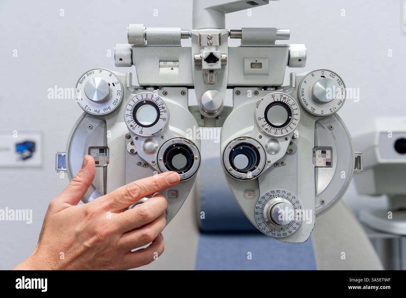 Anonymous person with index finger on cylinder axis indicator of ...