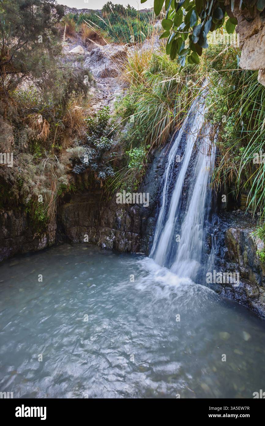 Beautiful waterfall and small scenic lake with clear water. Walk in the ...
