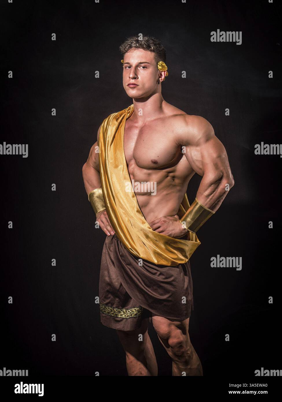 Serious young man in Greek god or Roman aristocrat costume with ...