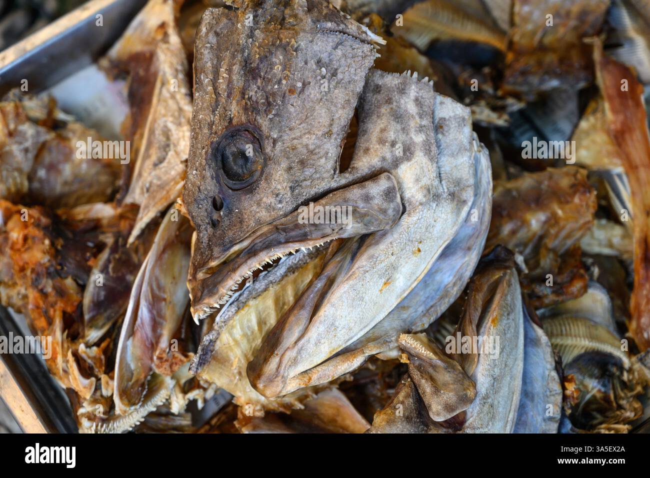 Dried fish heads for sale inside the Maeklong Railway market, one of ...
