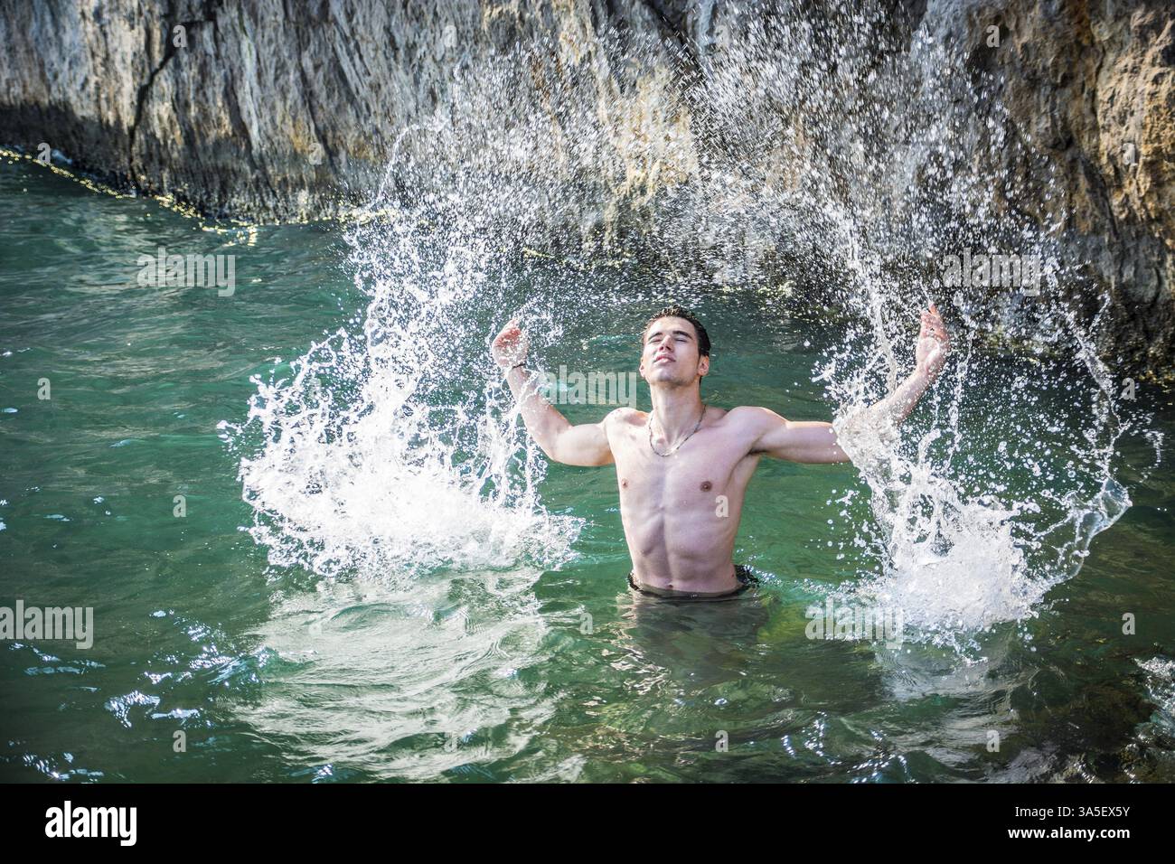 Man splashes in water splashing hi-res stock photography and images - Alamy